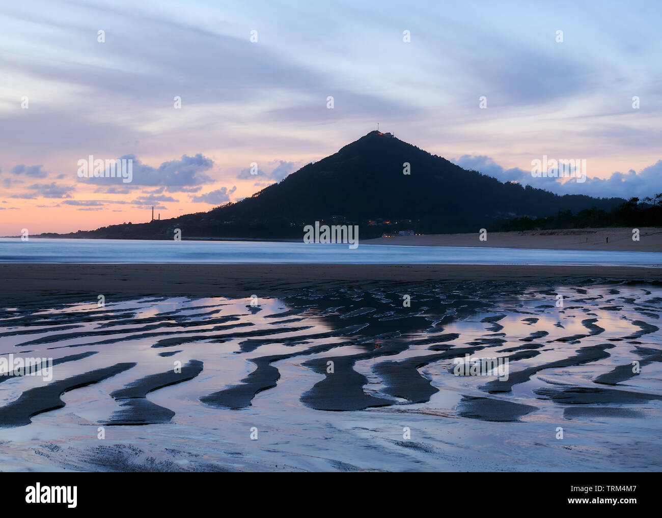 Beach of moledo at the end of the day, with a view to trega mountain on ...