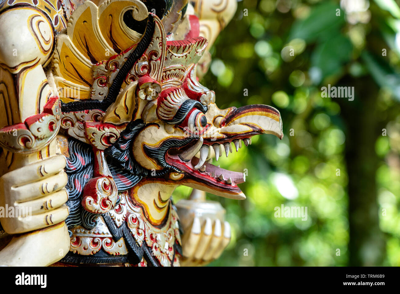 Balinese ancient colorful bird god Garuda with wings, close up ...