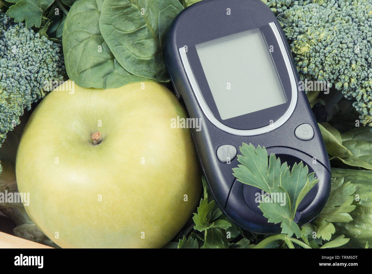 Glucose meter and fresh ripe green fruits with vegetables as healthy ...