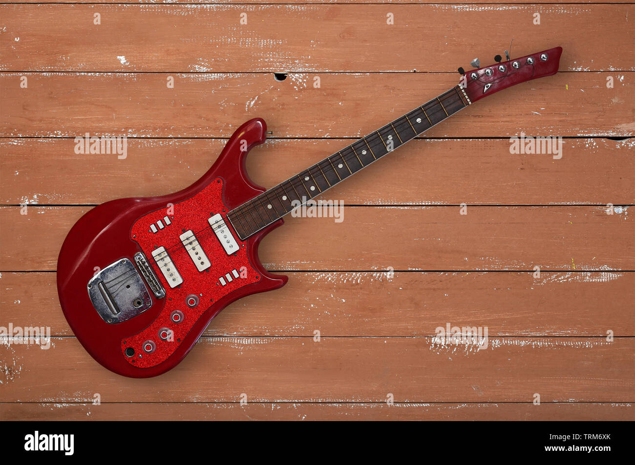 Musical instrument - Red retro guitar on a wooden background Stock ...
