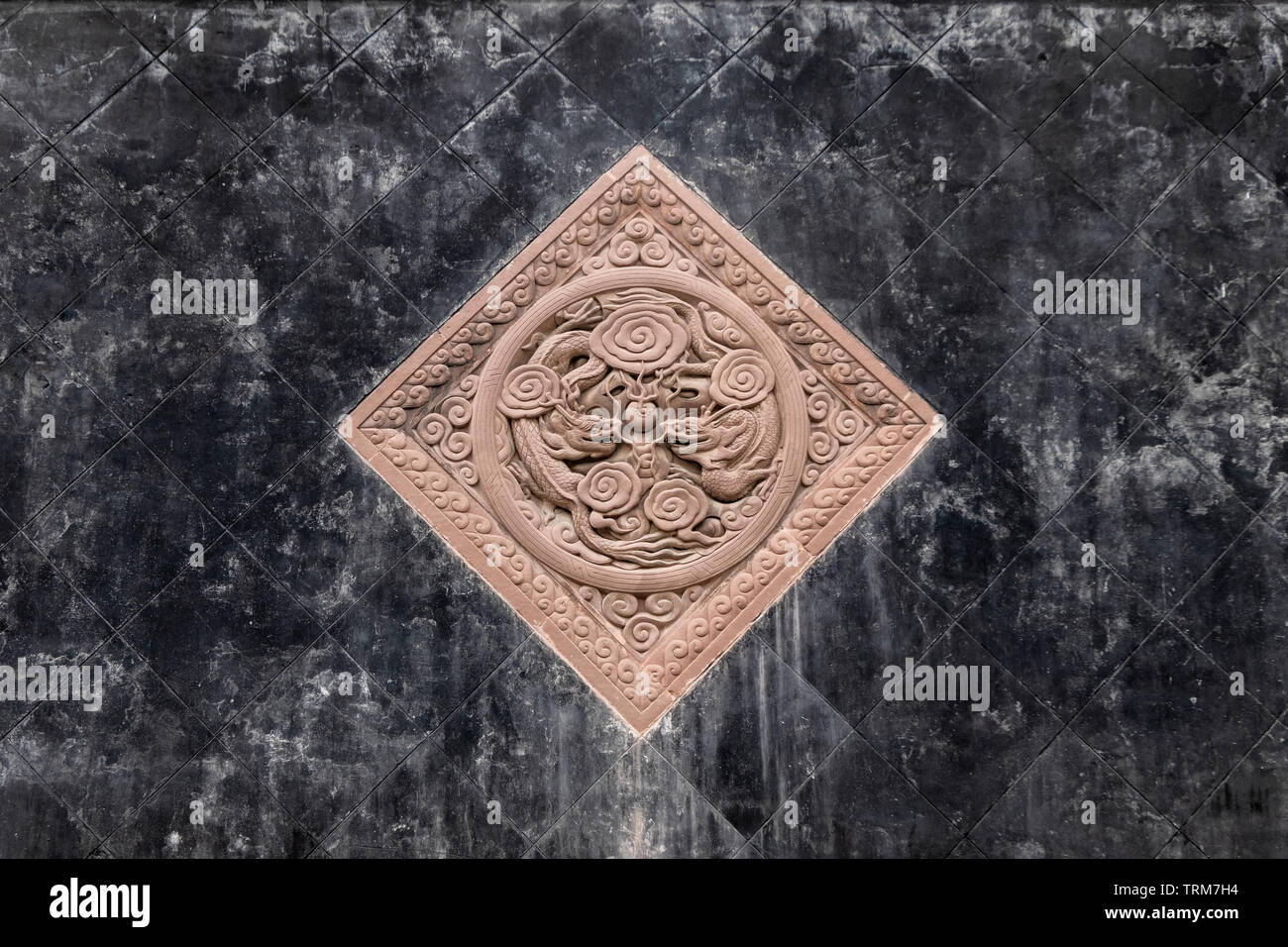 Black tiles floor with brown stone carving of dragons in chinese park ...