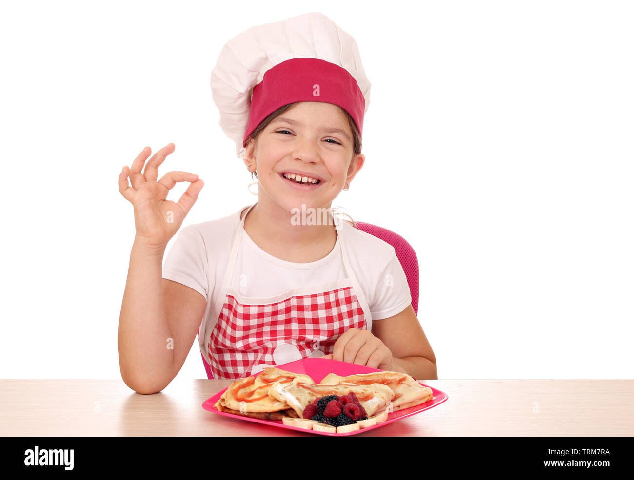 Happy little girl cook with sweet crepes and ok hand sign Stock Photo ...