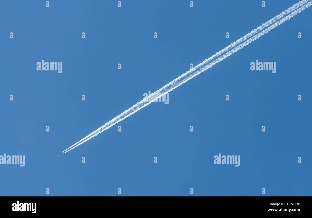 Aircraft trace in the sky Stock Photo - Alamy