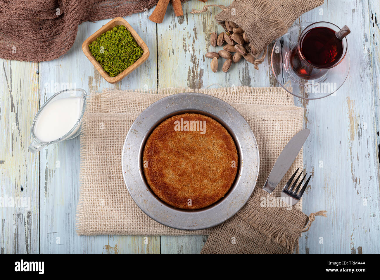 Turkish dessert kunefe, kunafa, kadayif with pistachio powder and ...