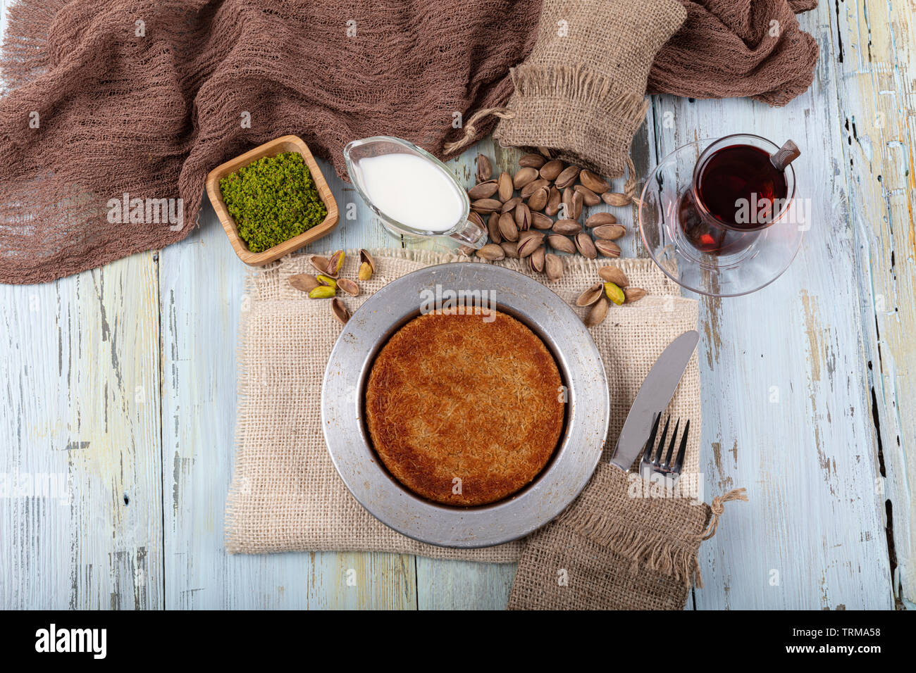 Turkish dessert kunefe, kunafa, kadayif with pistachio powder and ...