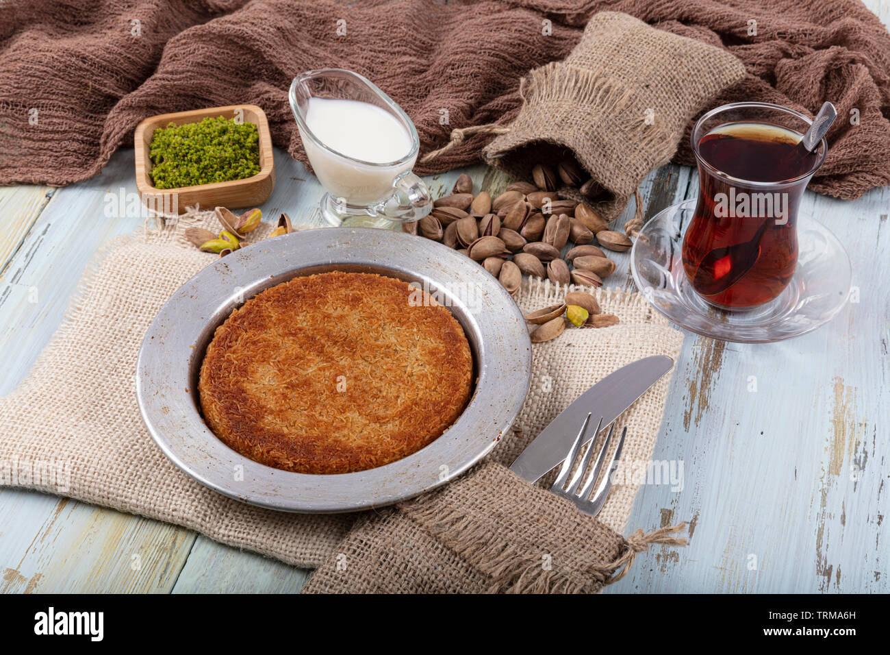 Turkish dessert kunefe, kunafa, kadayif with pistachio powder and ...