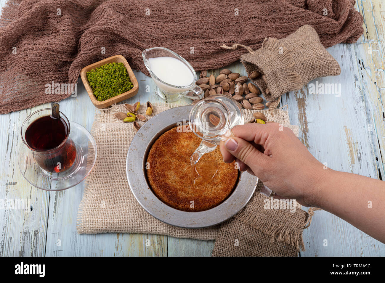 Turkish dessert kunefe, kunafa, kadayif with pistachio powder and ...