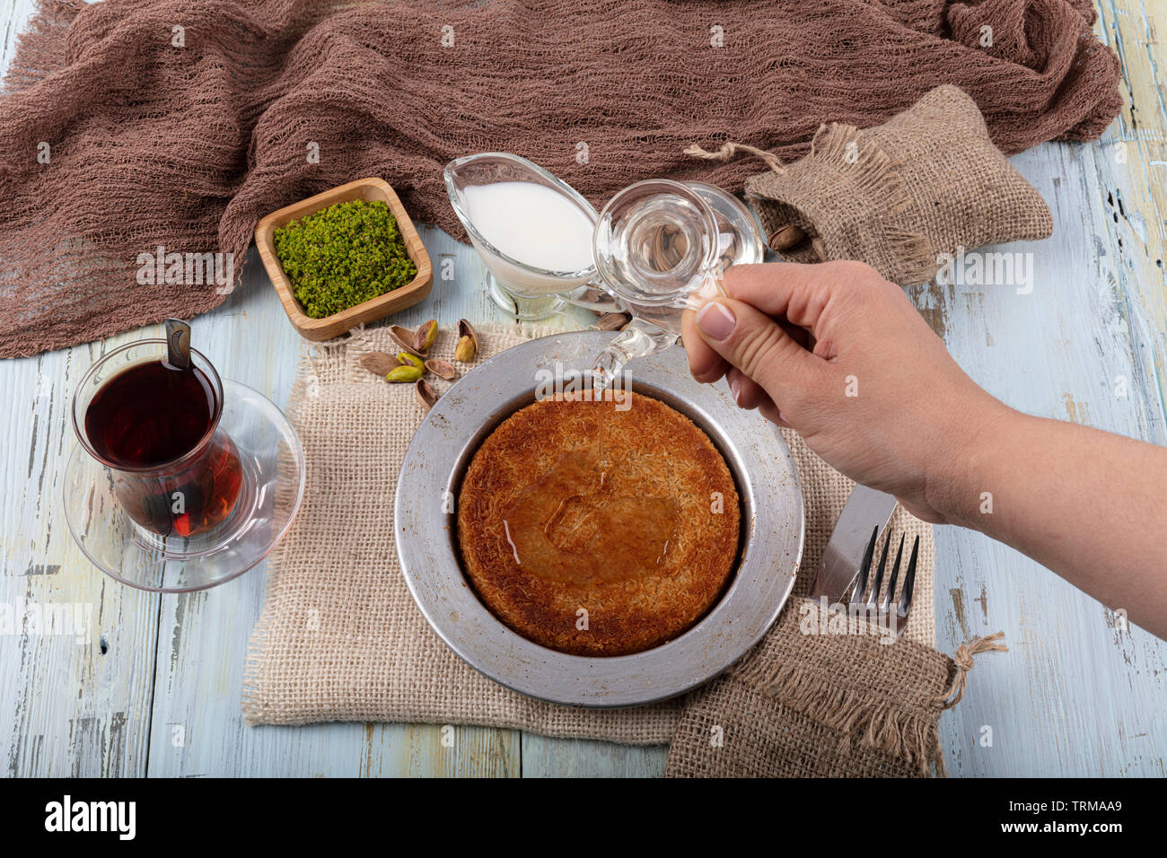 Turkish dessert kunefe, kunafa, kadayif with pistachio powder and ...