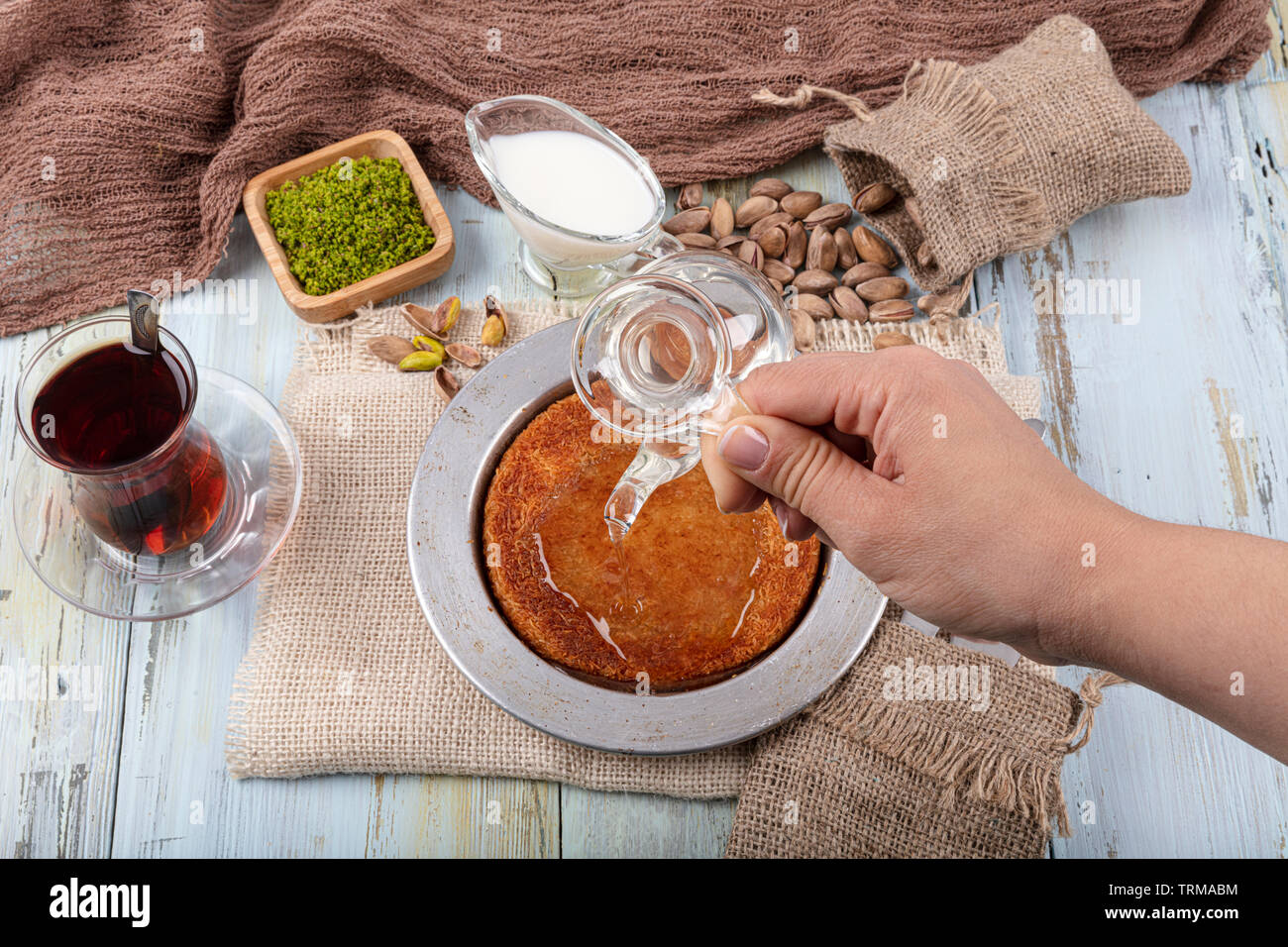 Turkish dessert kunefe, kunafa, kadayif with pistachio powder and ...