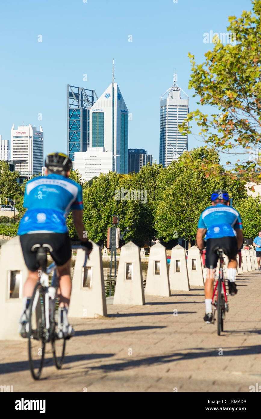 Two men cycle along the embankment at Claisebrook Cove in East Perth ...