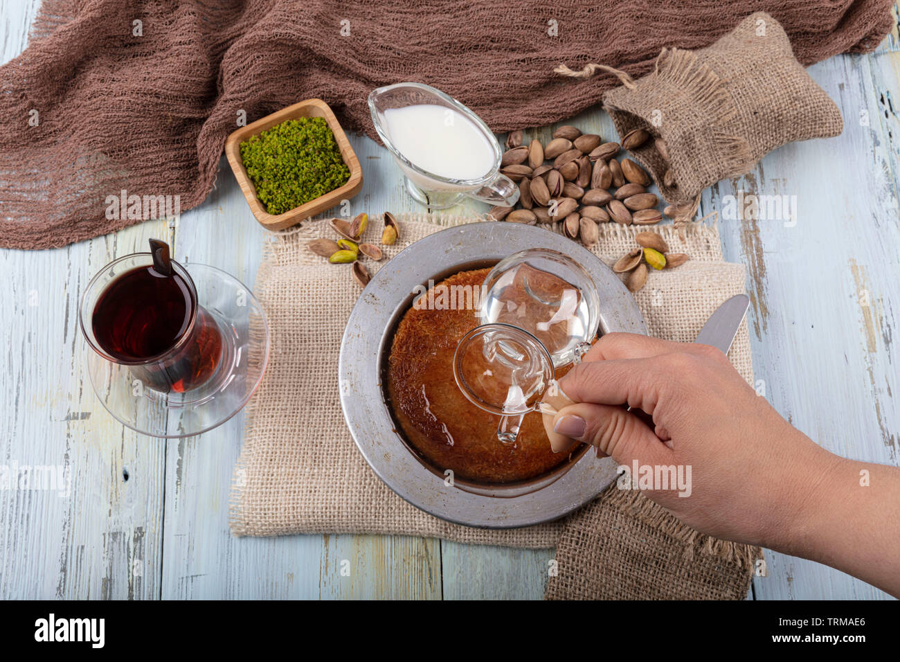 Turkish dessert kunefe, kunafa, kadayif with pistachio powder and ...