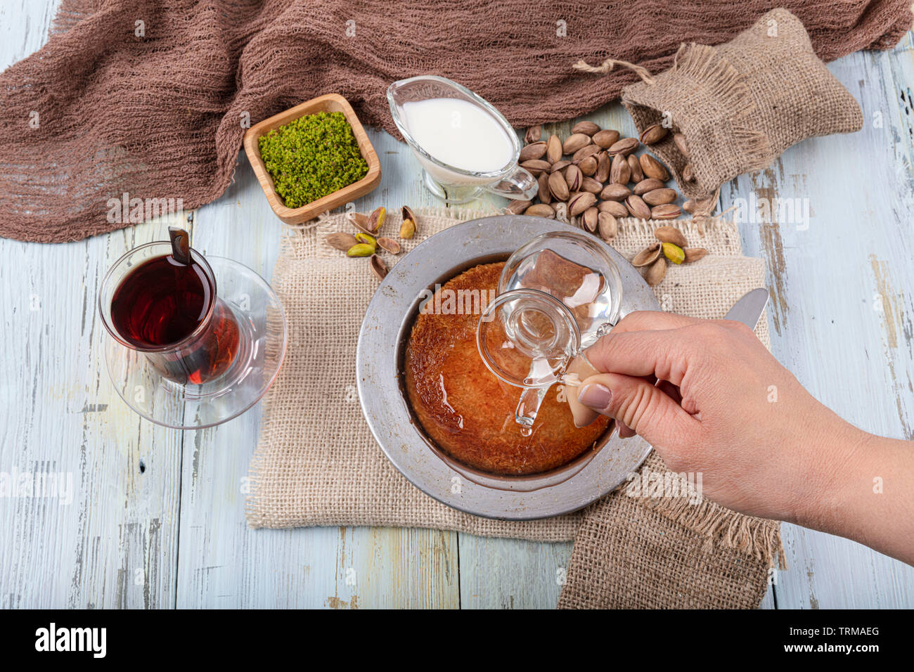 Turkish dessert kunefe, kunafa, kadayif with pistachio powder and ...