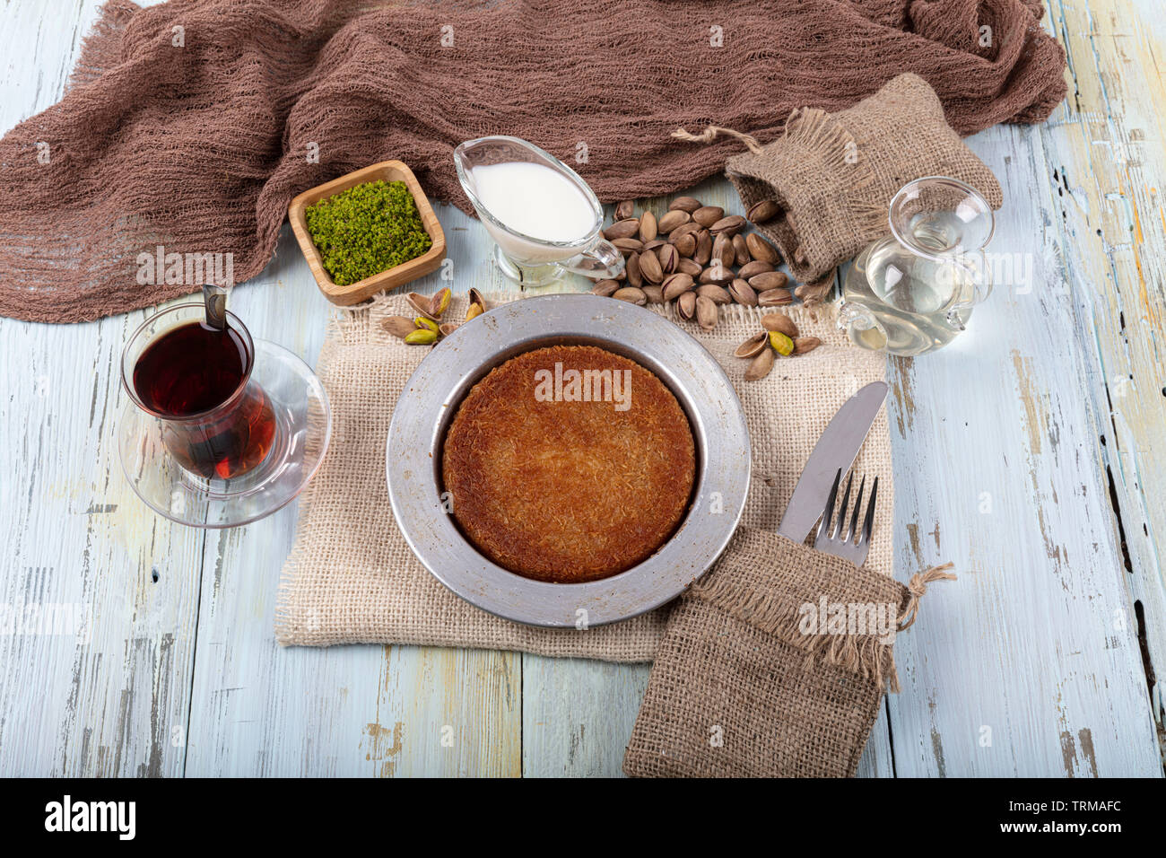 Turkish dessert kunefe, kunafa, kadayif with pistachio powder and ...