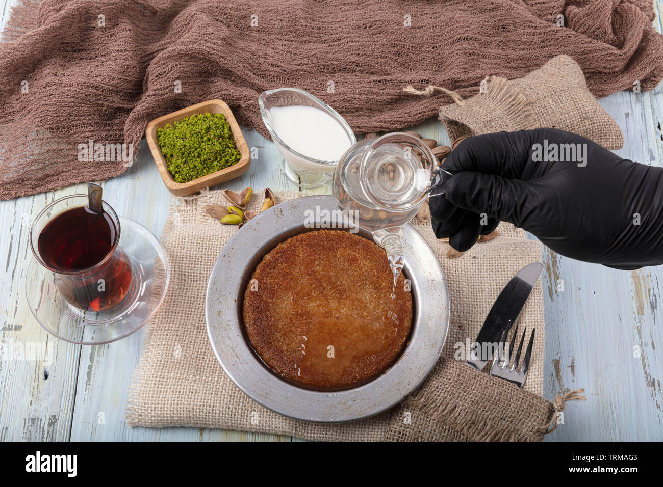 Turkish dessert kunefe, kunafa, kadayif with pistachio powder and ...