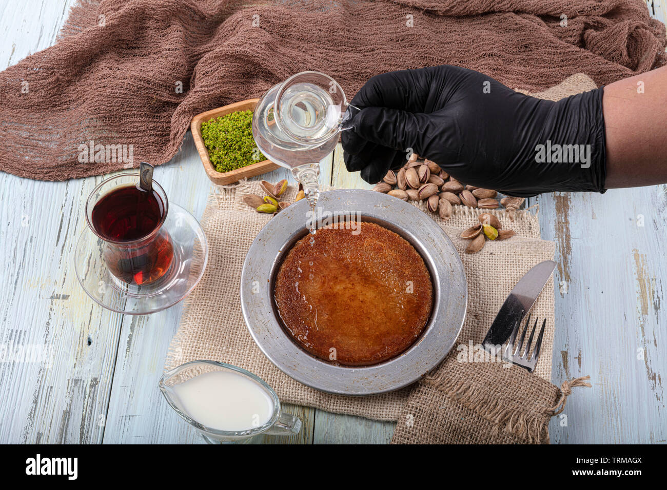 Turkish dessert kunefe, kunafa, kadayif with pistachio powder and ...