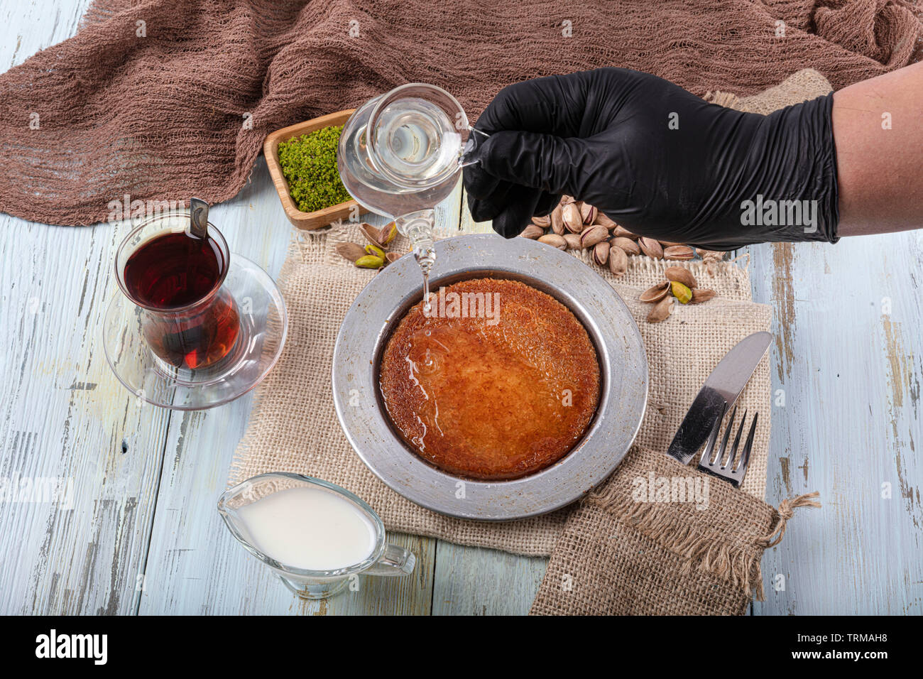 Turkish dessert kunefe, kunafa, kadayif with pistachio powder and ...