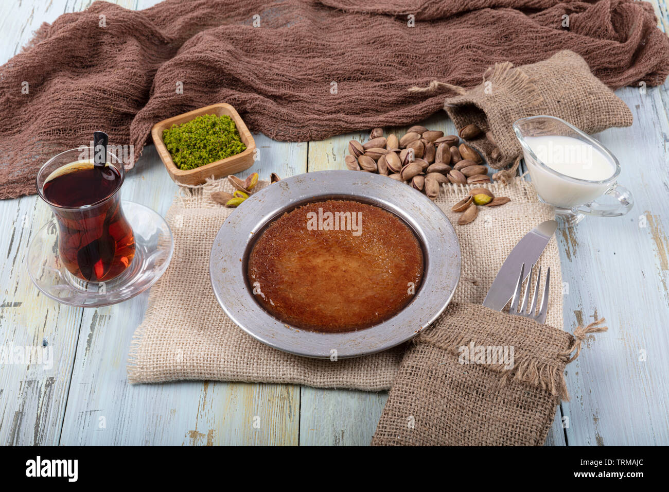 Turkish dessert kunefe, kunafa, kadayif with pistachio powder and ...