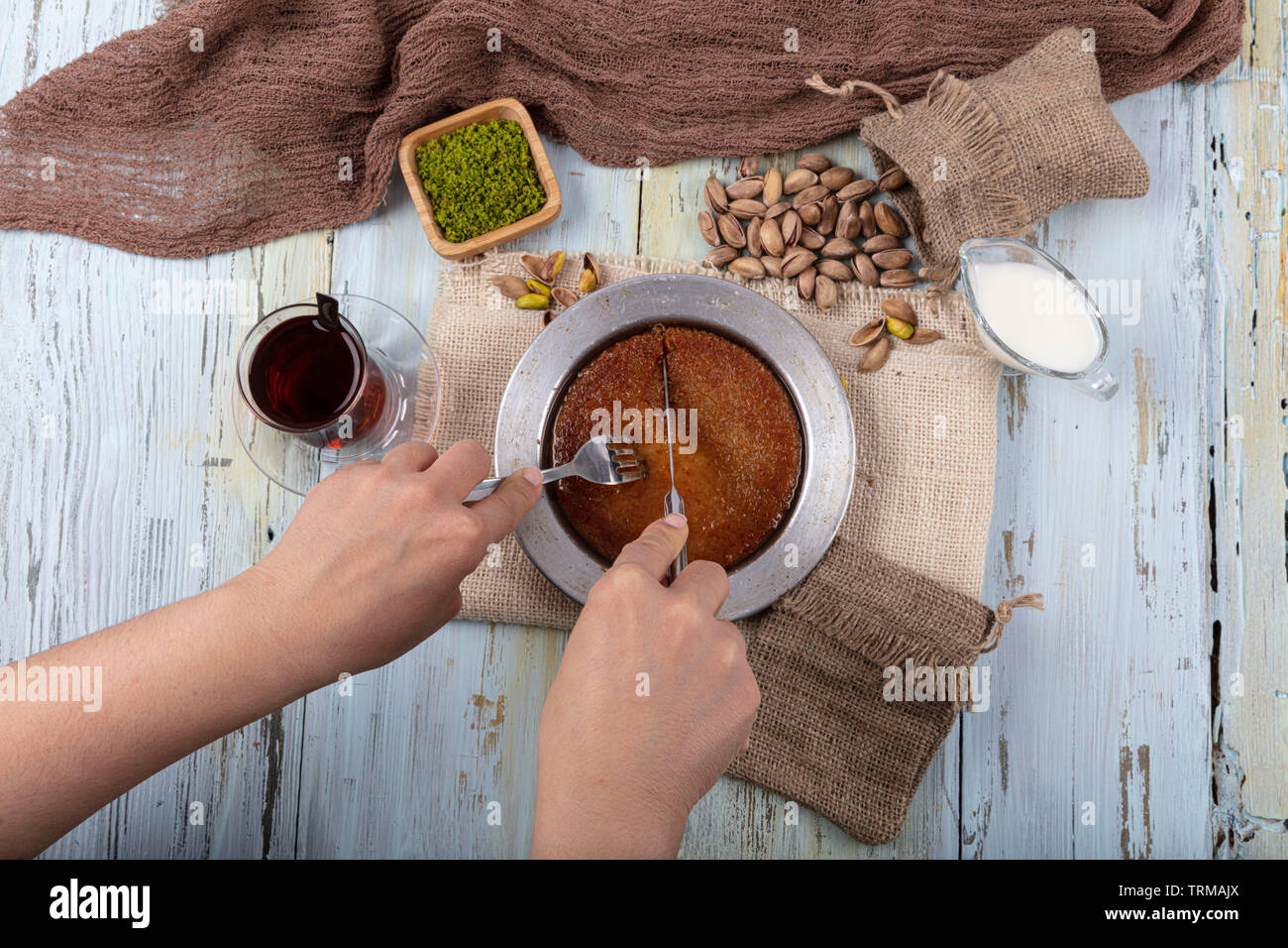 Turkish dessert kunefe, kunafa, kadayif with pistachio powder and ...