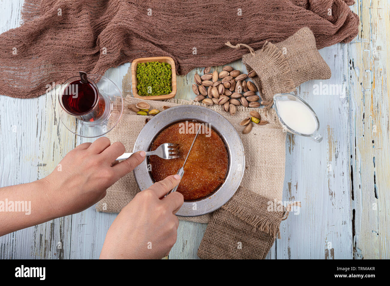 Turkish dessert kunefe, kunafa, kadayif with pistachio powder and ...