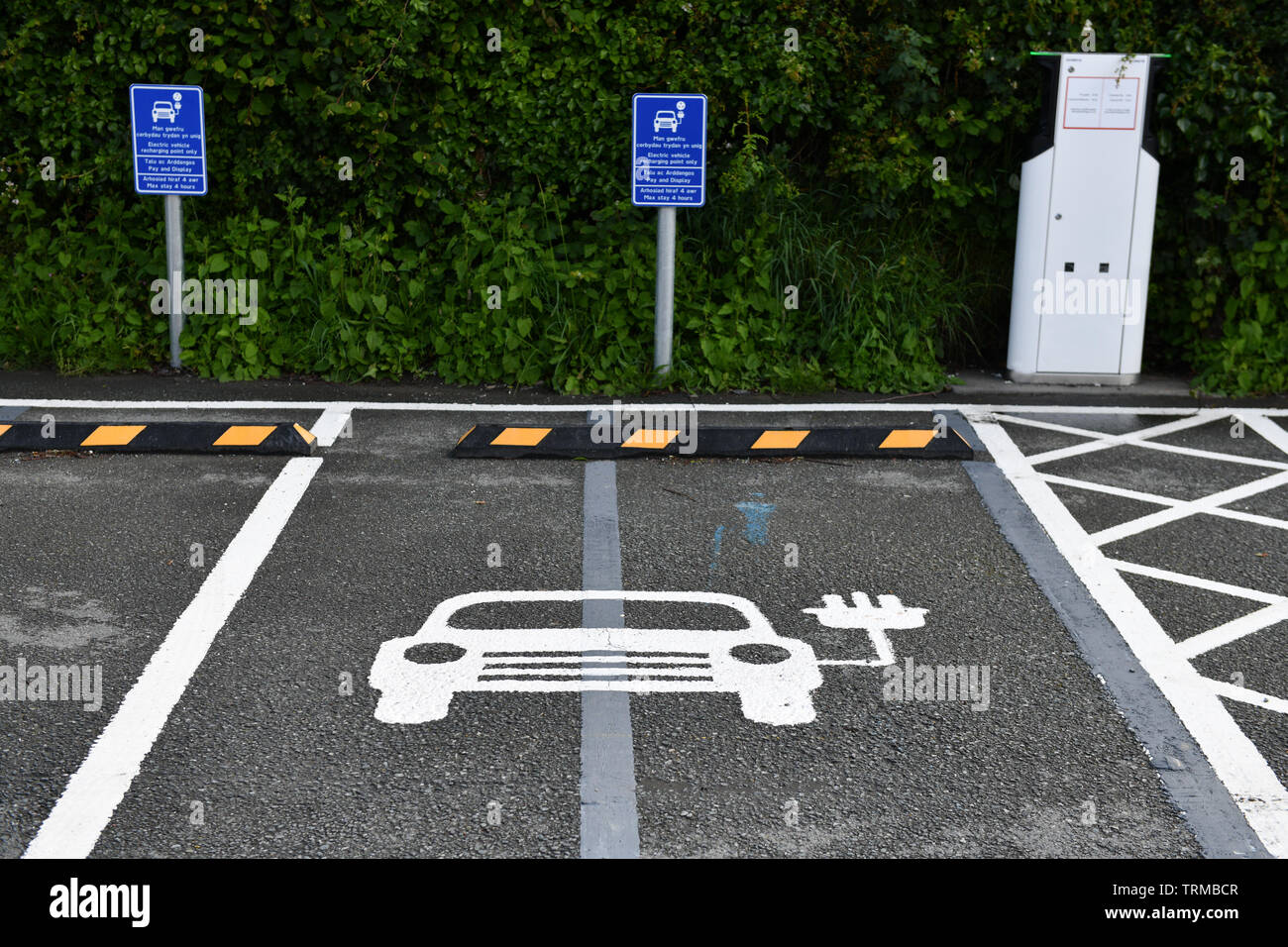 A electric vehicle charging bay and parking spot with a symbol of an ...