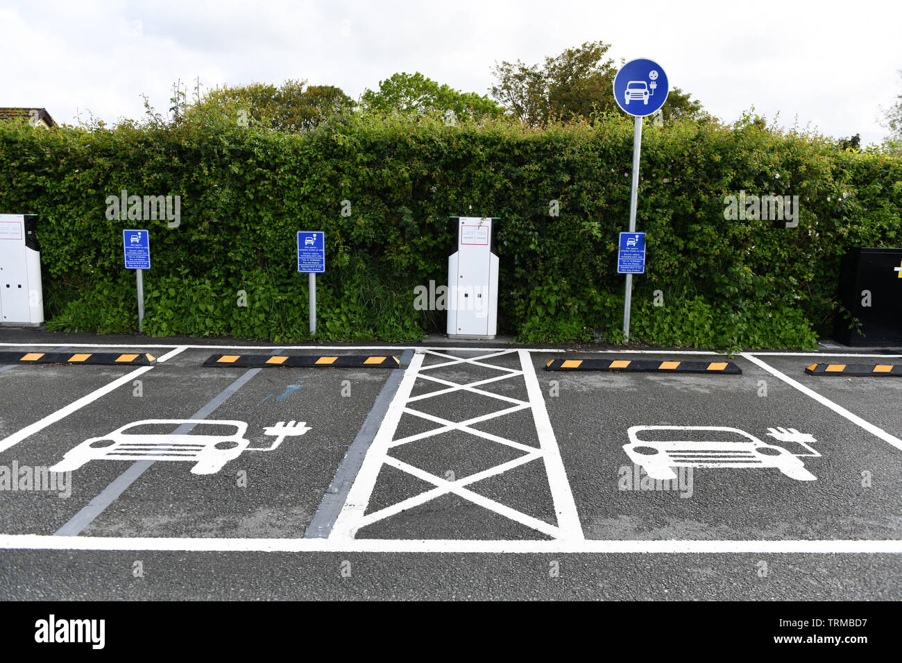 A electric vehicle charging bay and parking spot with a symbol of an ...