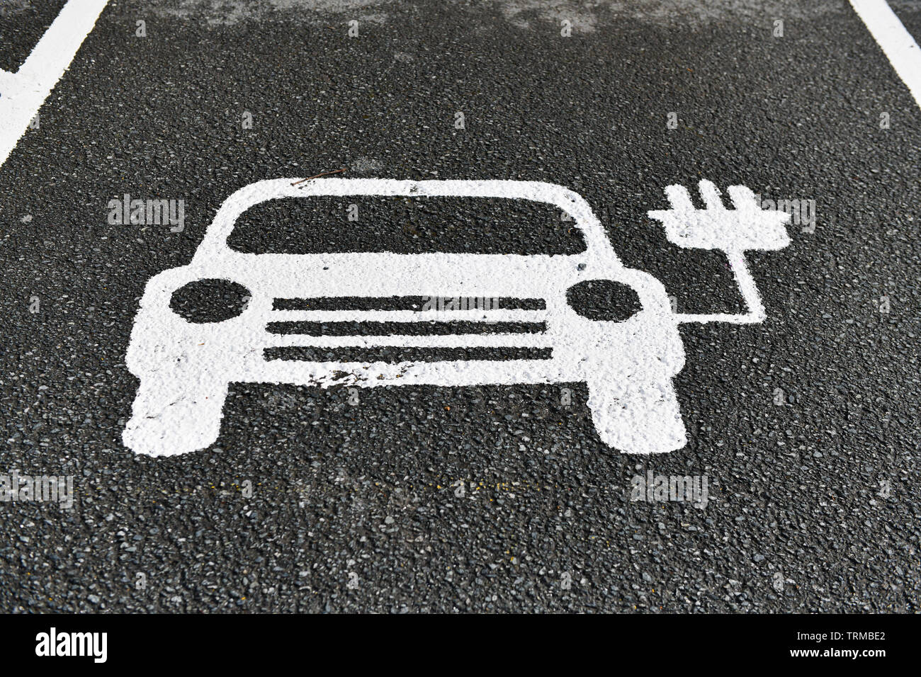 A electric vehicle charging bay and parking spot with a symbol of an ...