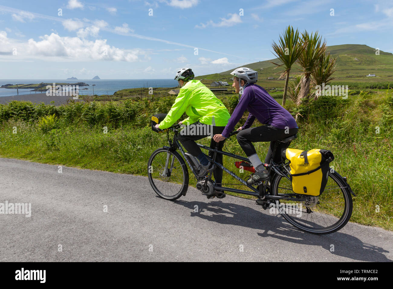 Senior Couple riding a tandem bicycle, Valentia Island, County Kerry ...