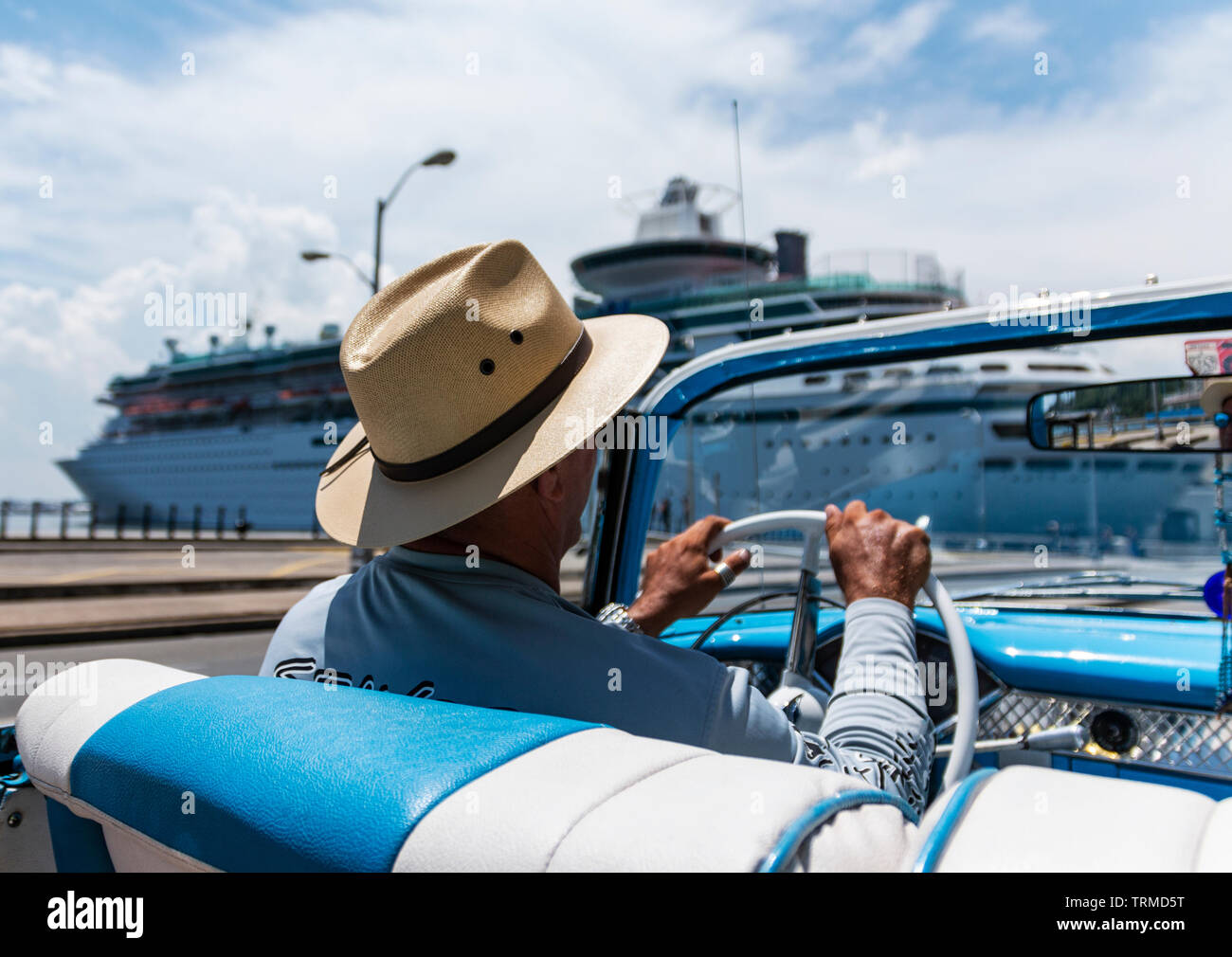 Picture of taxi driver driviing a restored convertible in Havan Cuba ...