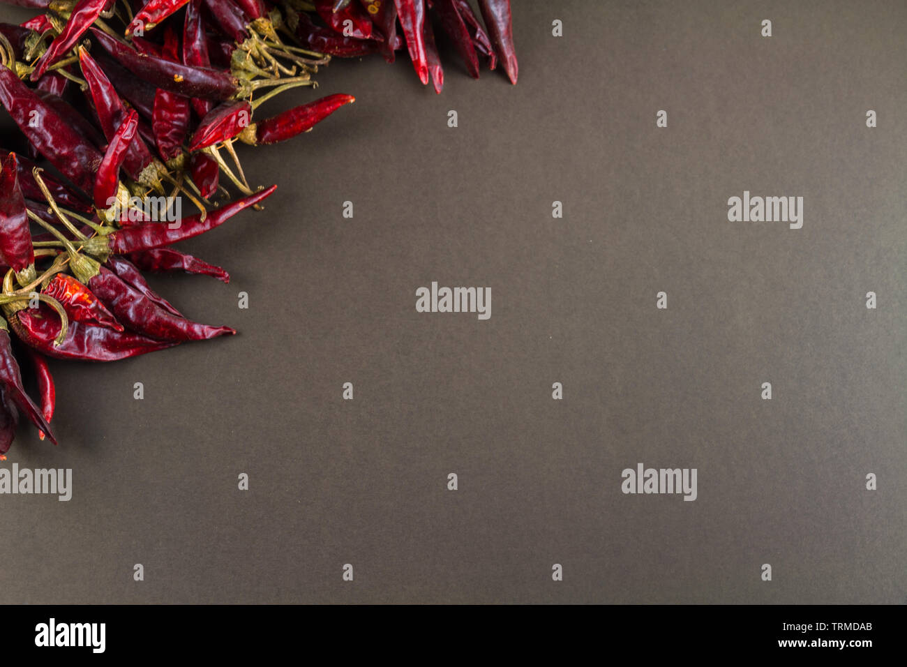 Hungarian paprika pepper string, grey background, copy space on right ...