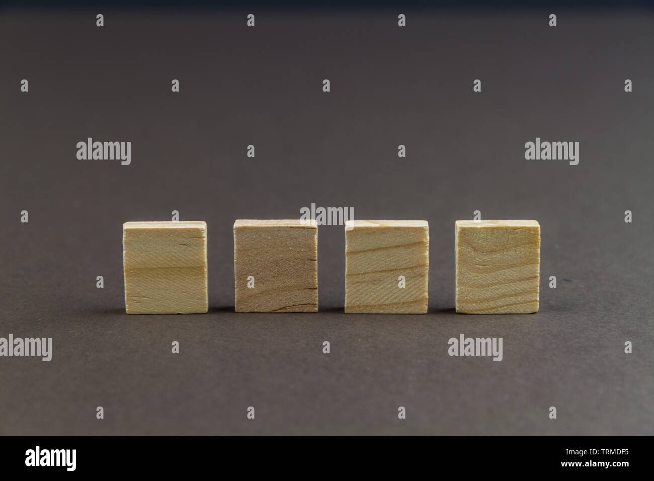 Four wood blocks against dark background, graphic resource, template ...