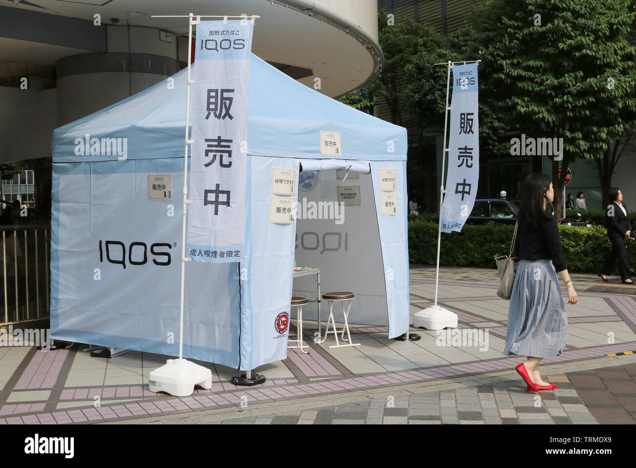A pop-up shop located in a tent promoting IQOS smokeless cigarette ...
