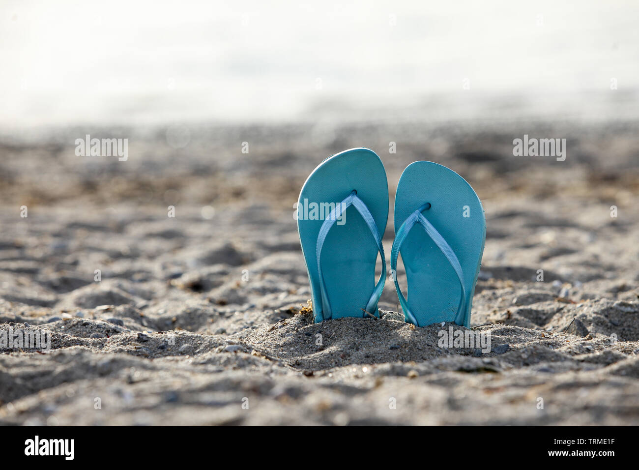 Flip flops on beach sand Stock Photo - Alamy