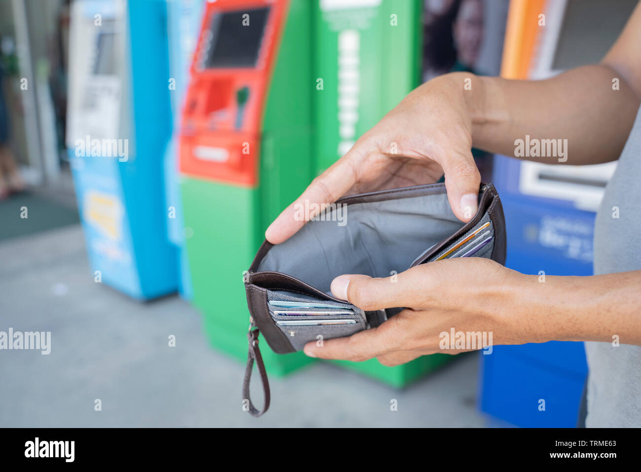 Empty wallet (no money) in the hands of an asian man. Cost control ...