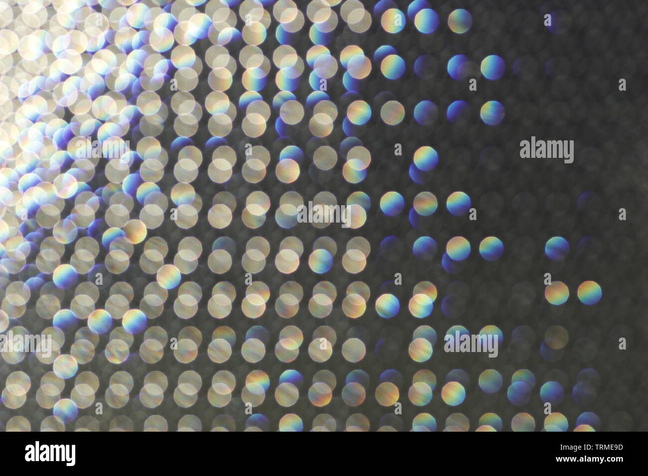 abstract colour image showing a pattern of rainbow coloured circles in ...