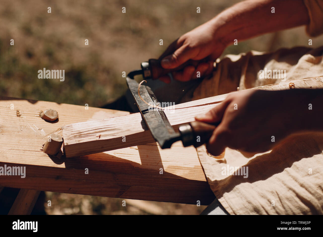 Carpenter planes a tree plane Stock Photo - Alamy