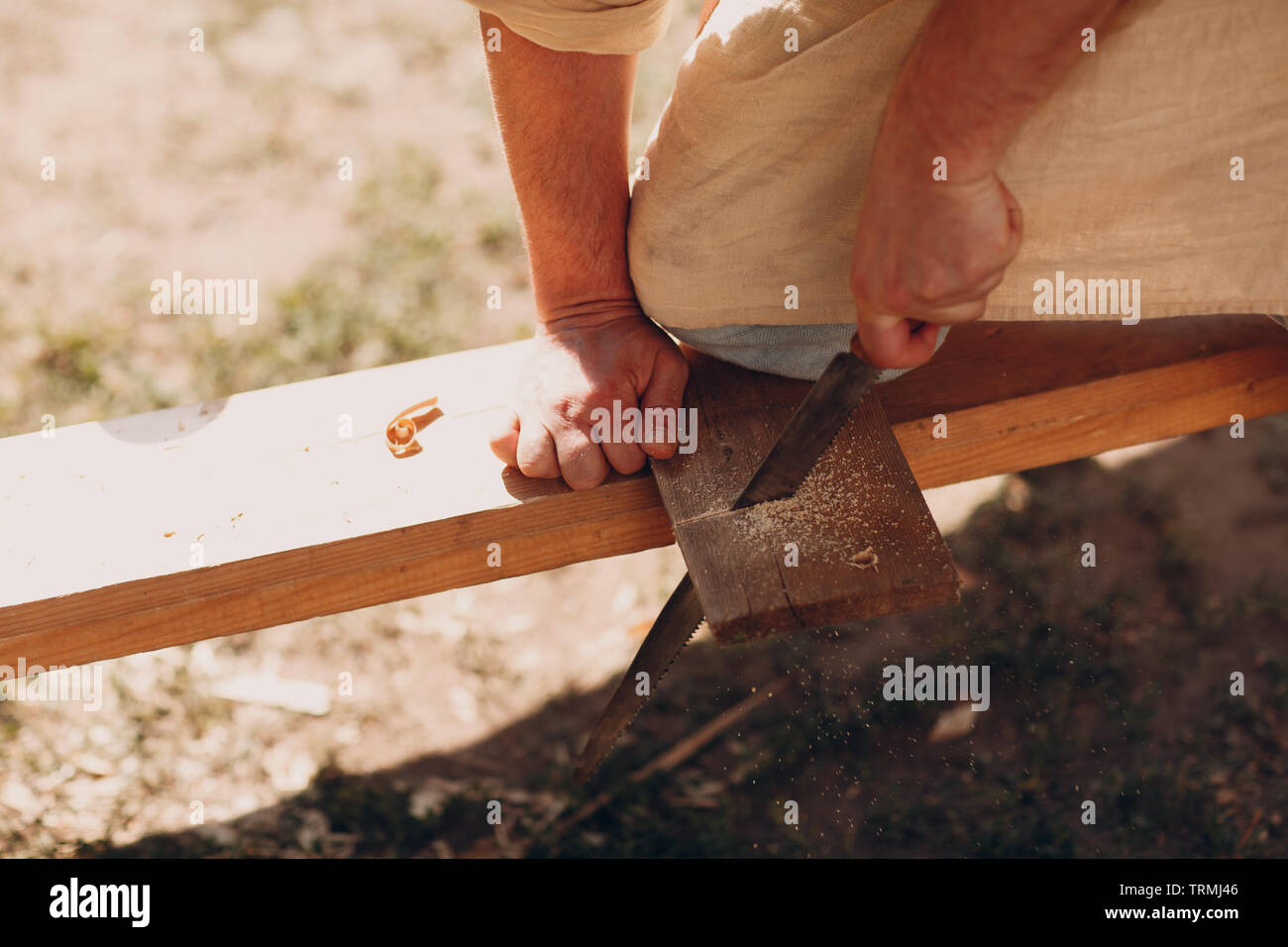 Carpenter sawing board with a hacksaw Stock Photo - Alamy