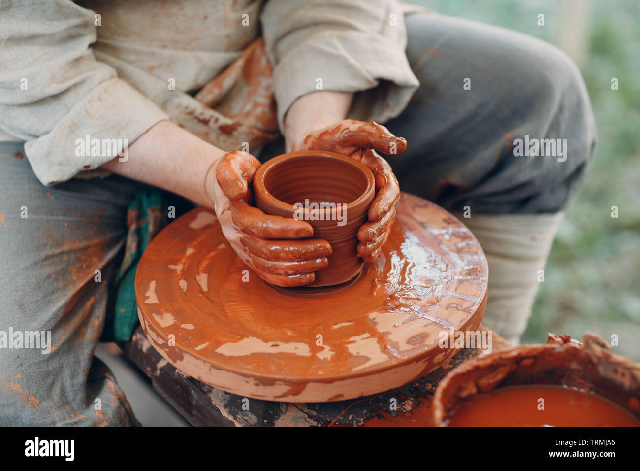 Potter makes a pot of clay Stock Photo - Alamy