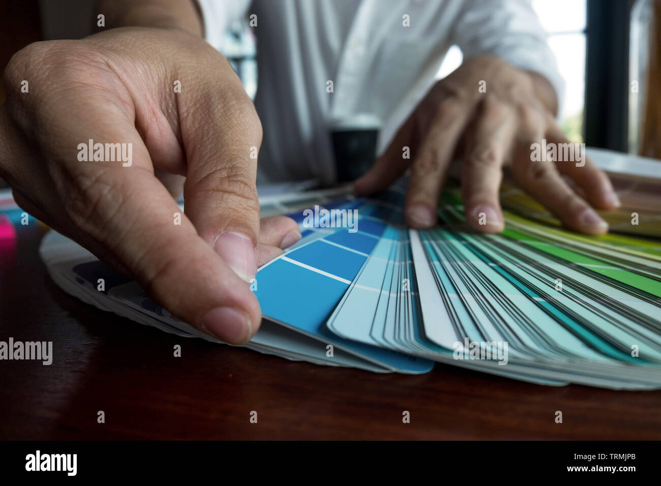 Graphic designer choose colors from the color bands samples for design ...