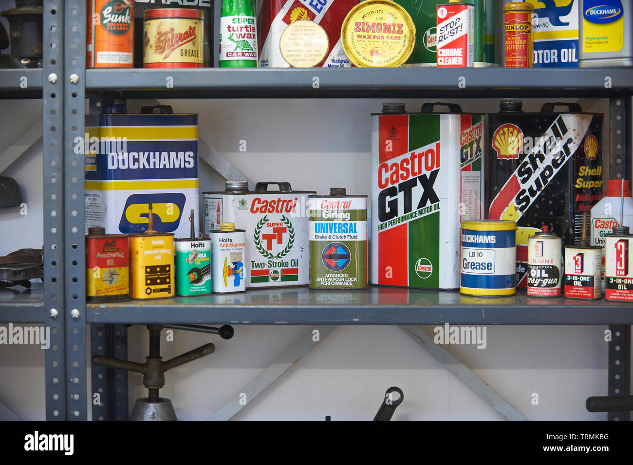 Assorted Oil can on display on metal shelving Stock Photo - Alamy