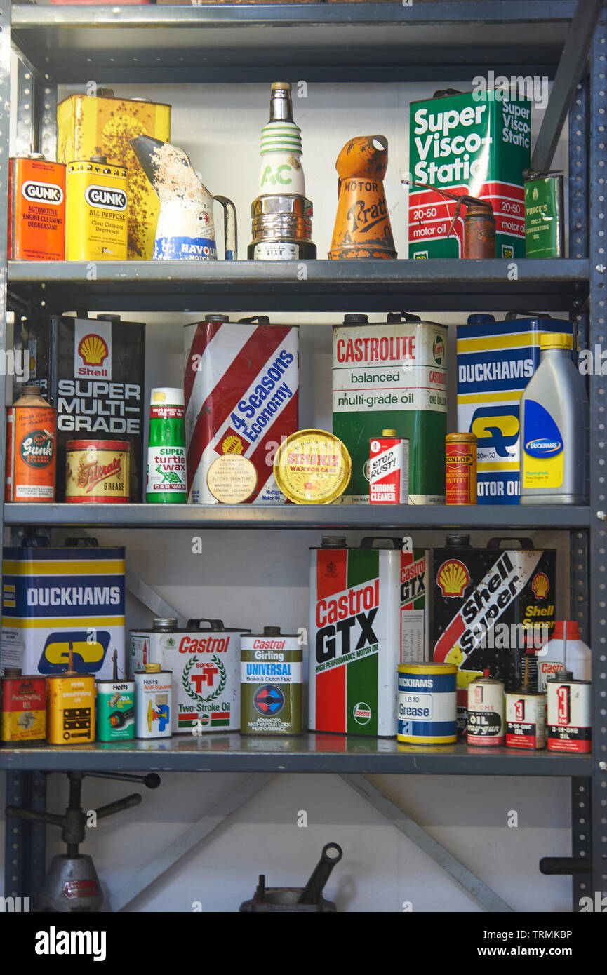 Assorted Oil can on display on metal shelving Stock Photo - Alamy