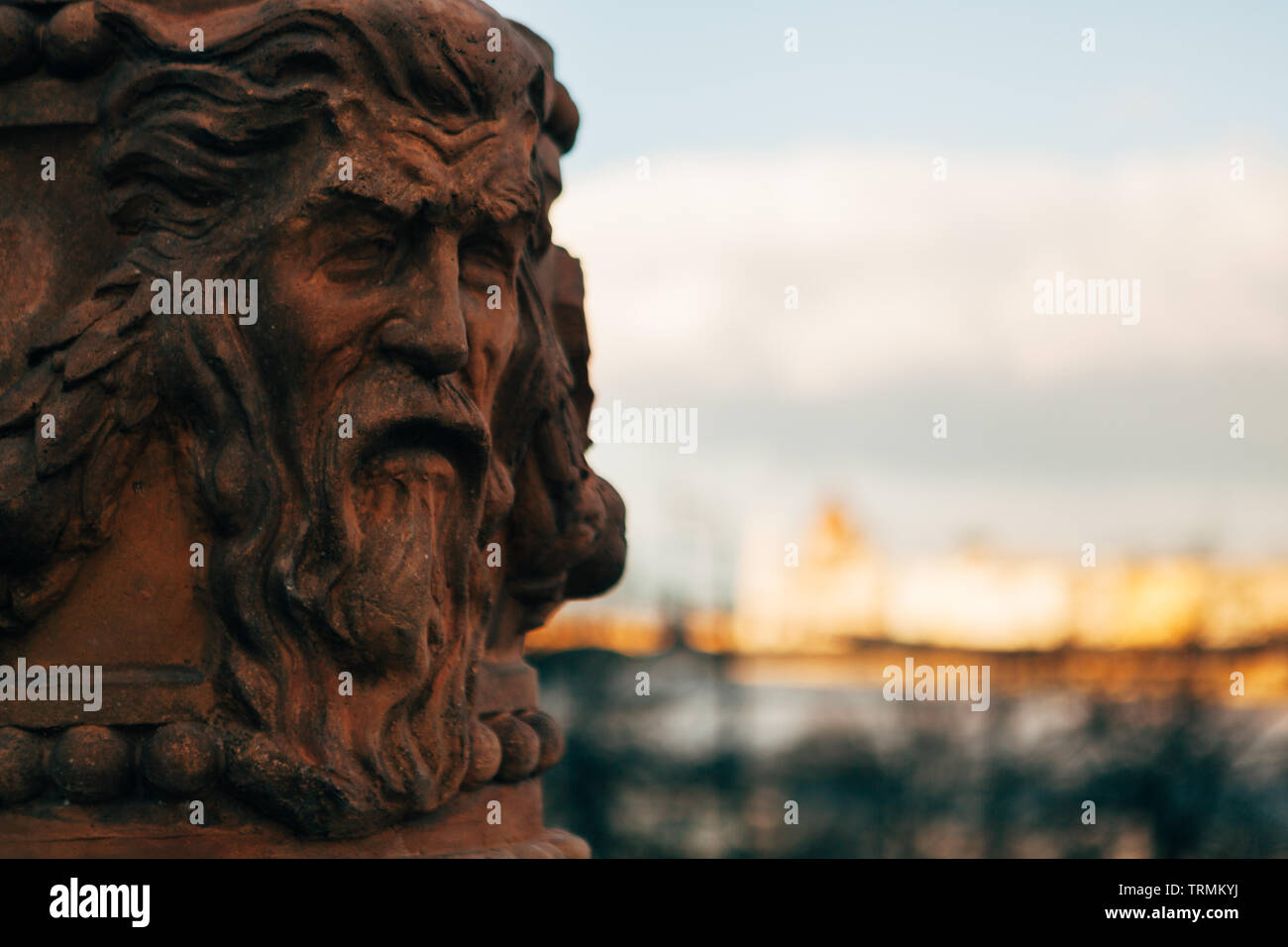 Ornamental face sculpture in Budapest with the Parliament in background ...