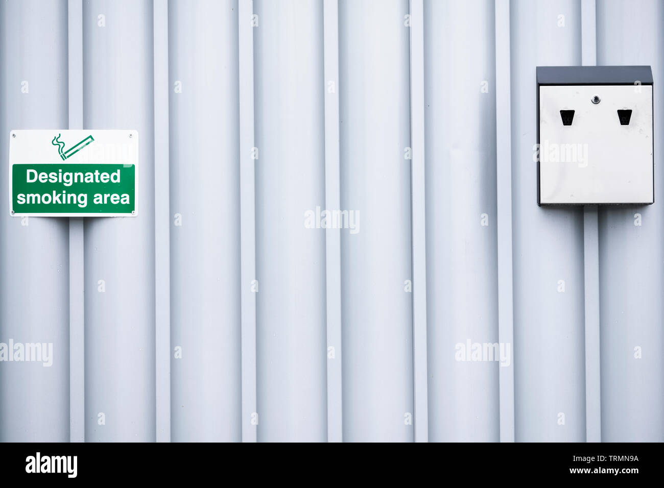 Designated smoking area sign and ash tray at office place of work Stock ...