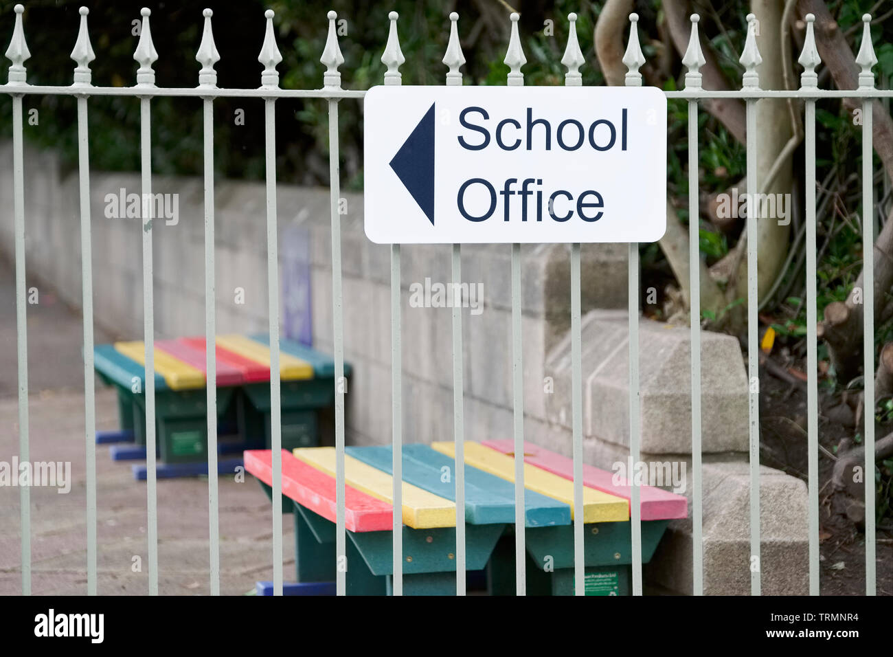 School office direction arrow sign in playground Stock Photo - Alamy