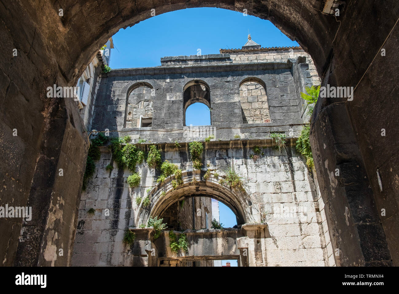Stone houses with windows and balconies in narrow street of old town of ...