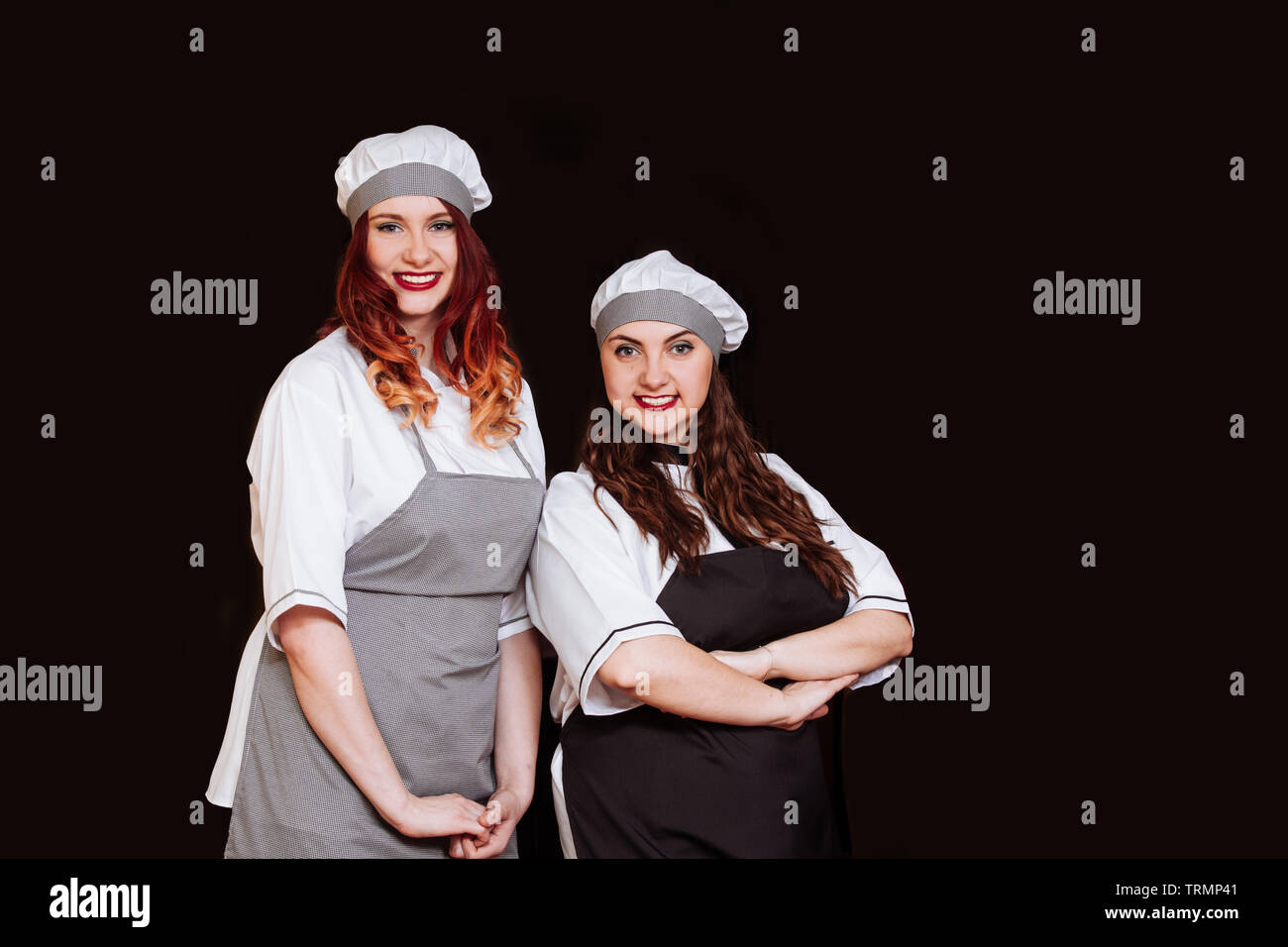 Portrait of young attractive cook women dressed white uniform isolated ...