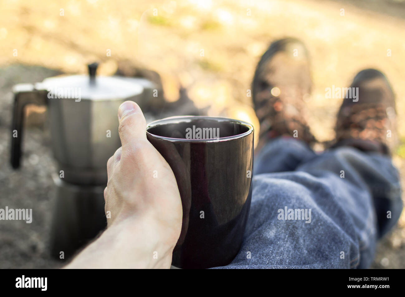 Preparing coffee with bonfire, resting during a camp in nature.First ...