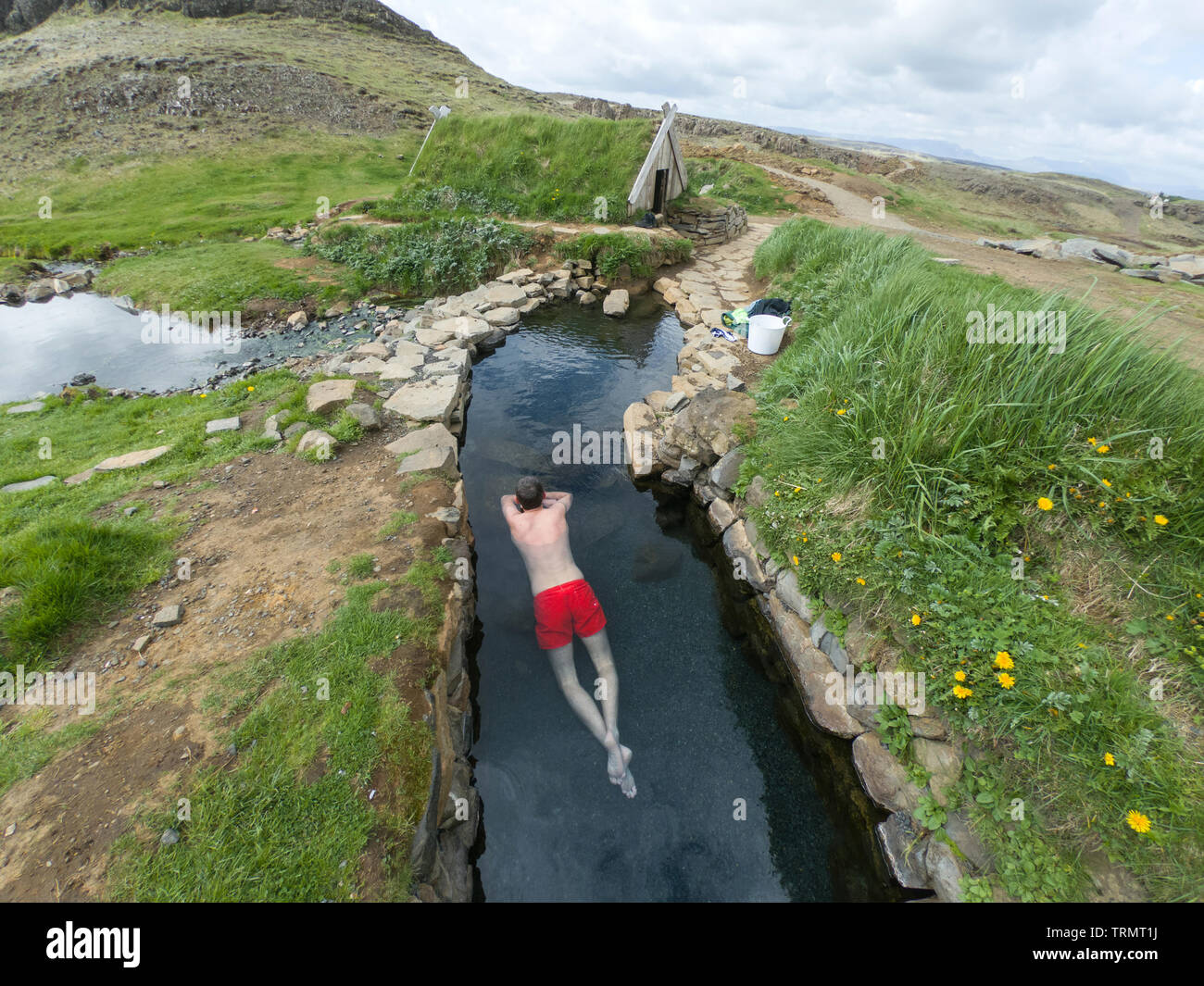 Man relaxing in a hot spring pool in Hrunalaug, Iceland Stock Photo - Alamy