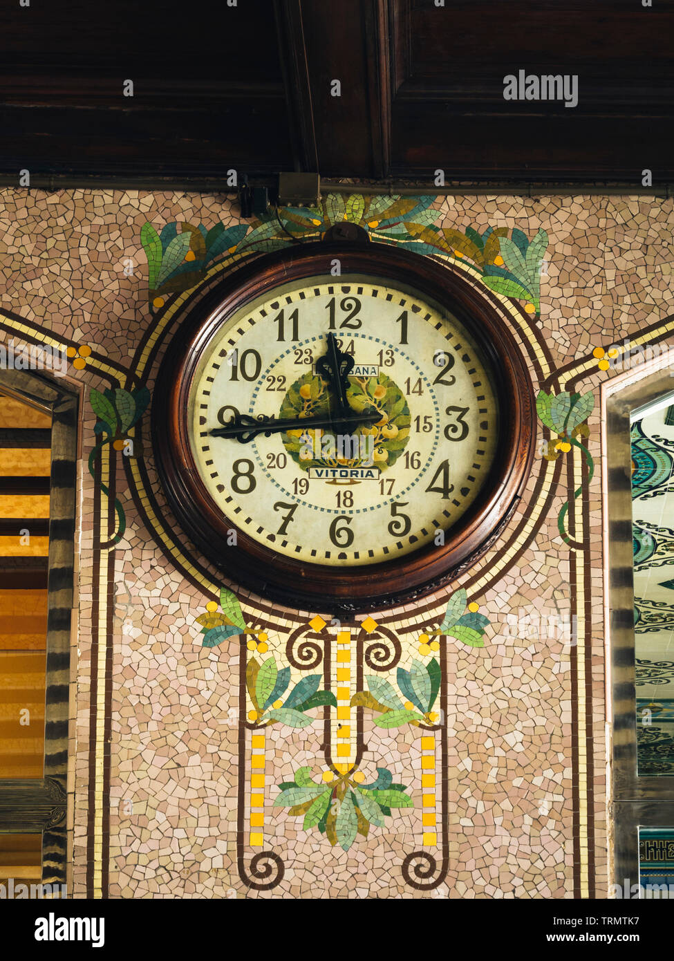 Vintage clock surrounded by design of mosaic tiles in ticket hall of ...