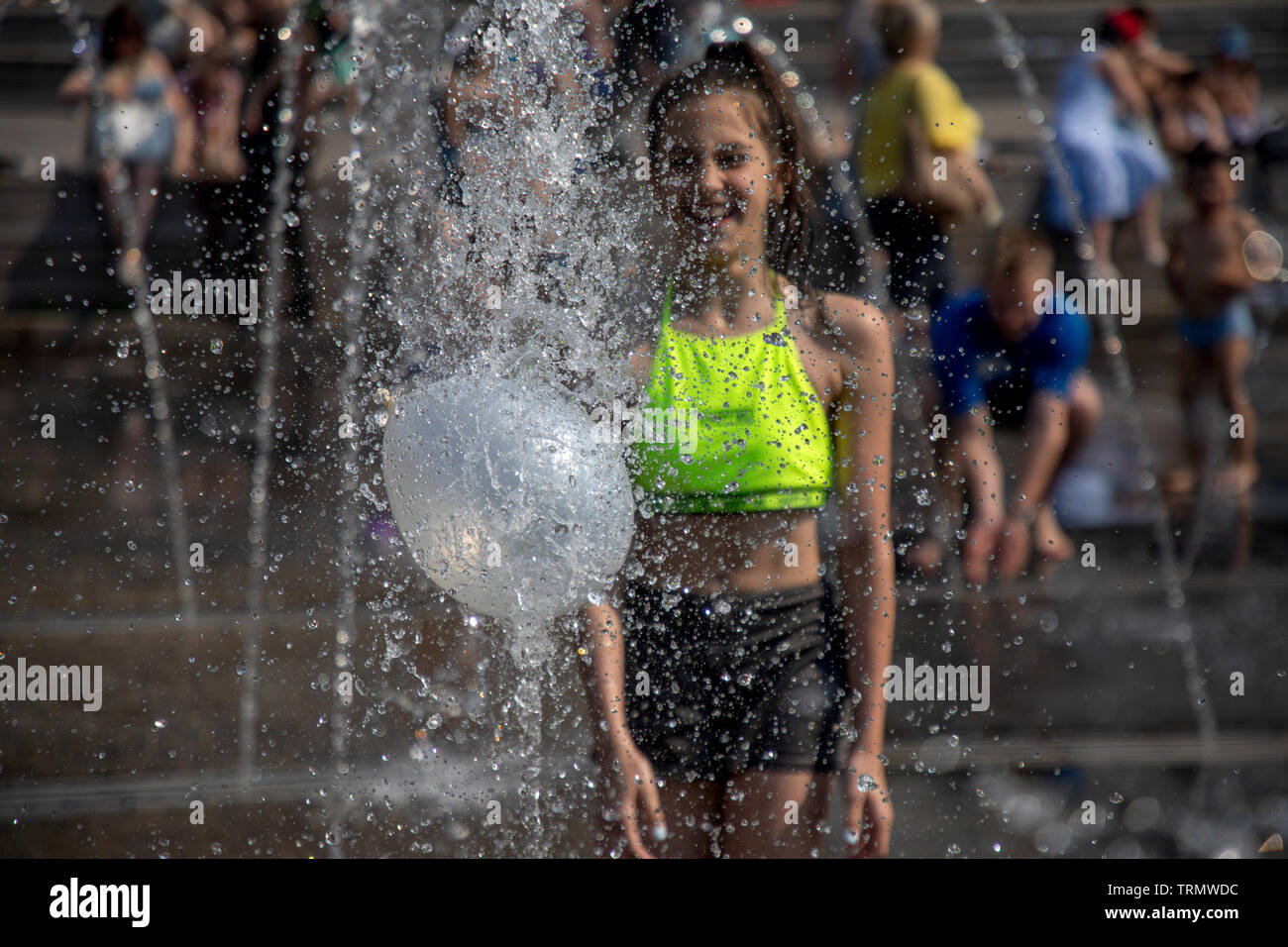 Children and adults swim in the pedestrian fountain in Muzeon Park ...