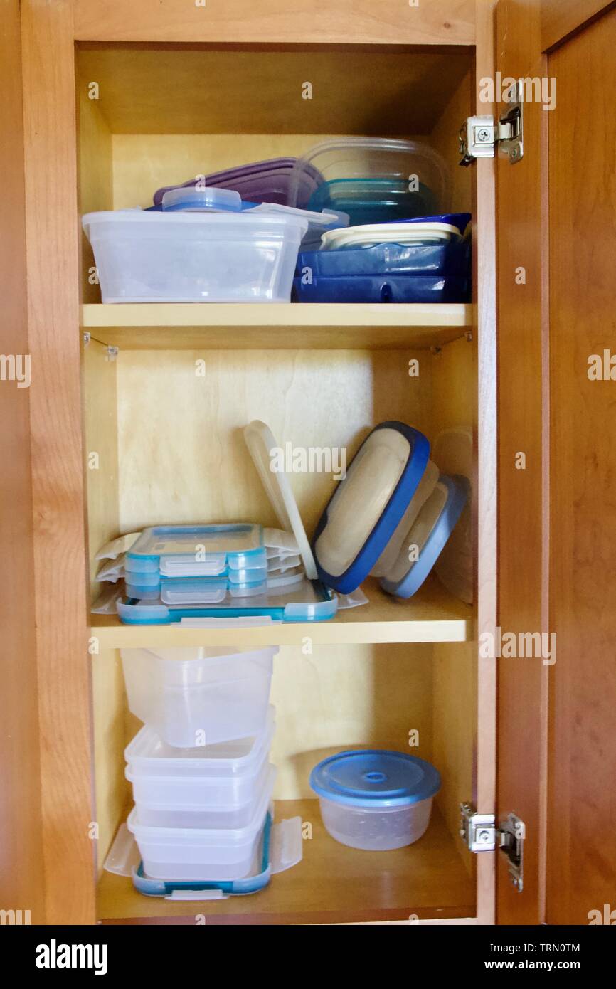 A cupboard full of plastic food containers Stock Photo - Alamy